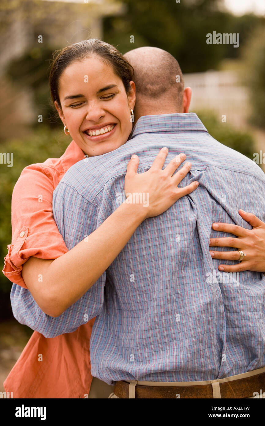Hispanic couple hugging Stock Photo - Alamy
