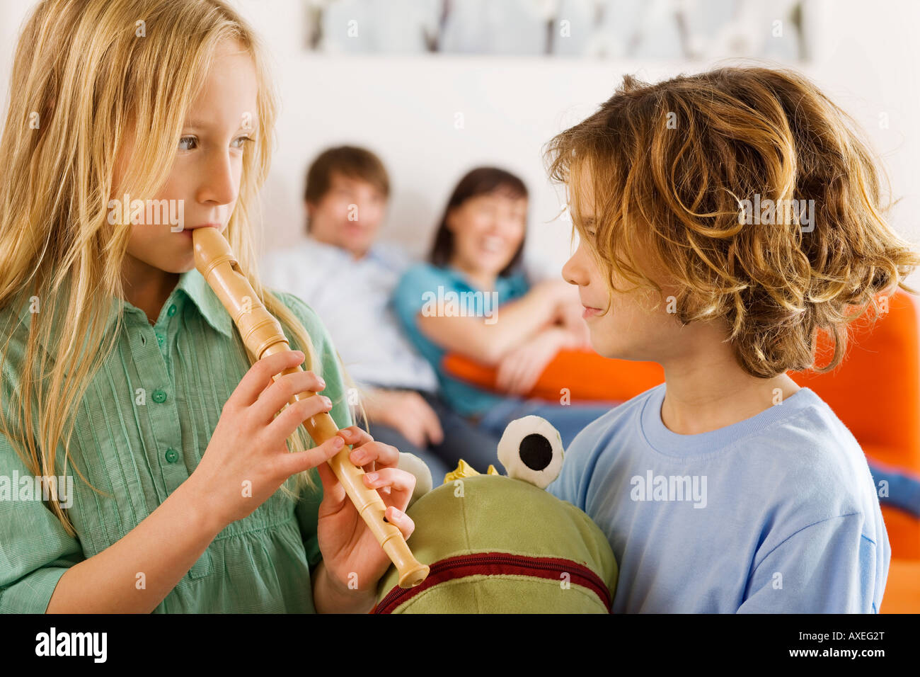 Boy (6-7) and girl (8-9), playing recorder Stock Photo - Alamy