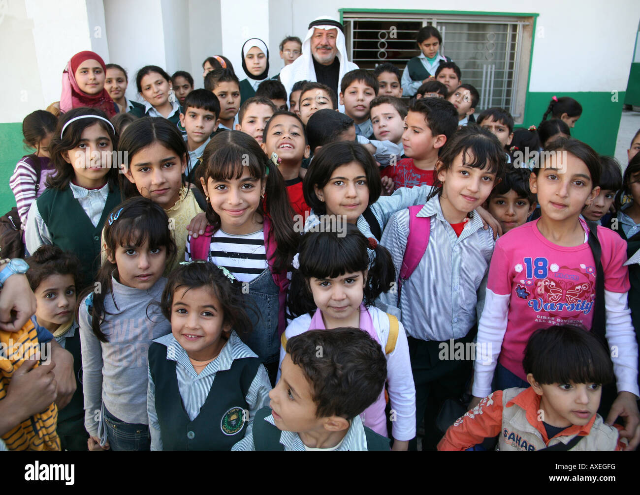 The school director and students in the school yard in Amman Many Iraqi ...