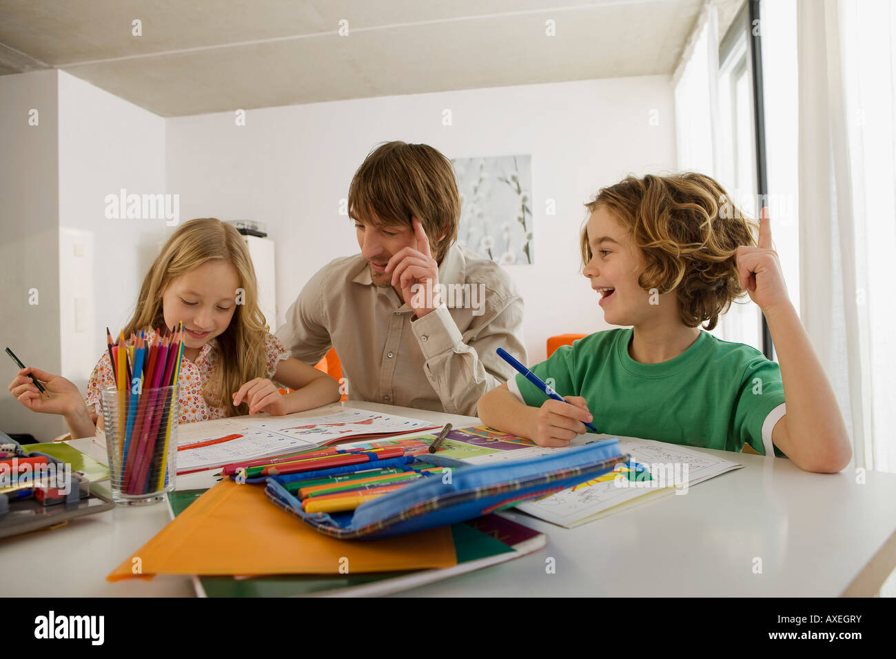 Father and children doing homework Stock Photo - Alamy