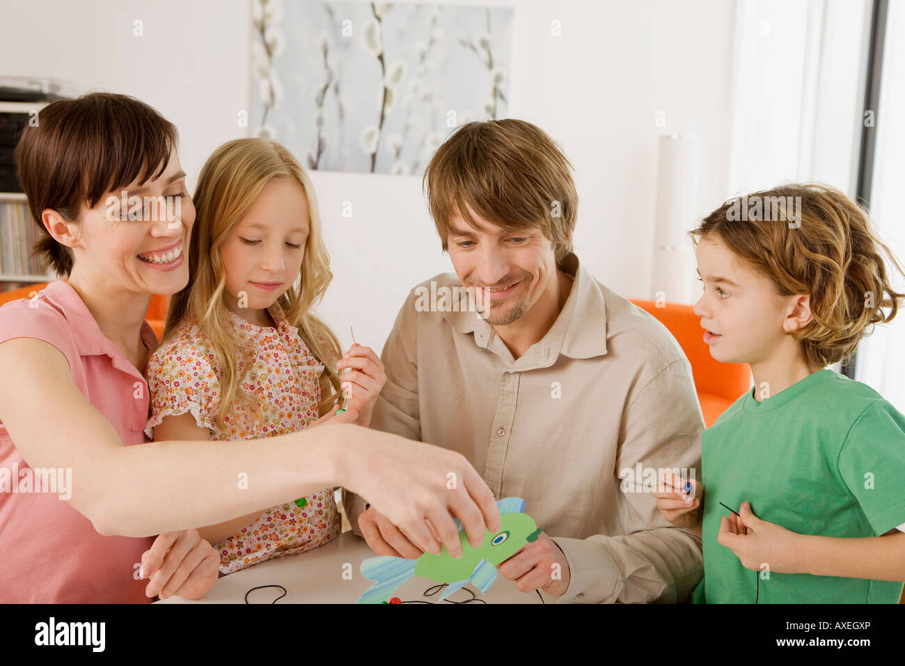 Family doing handicraft, smiling, portrait Stock Photo - Alamy