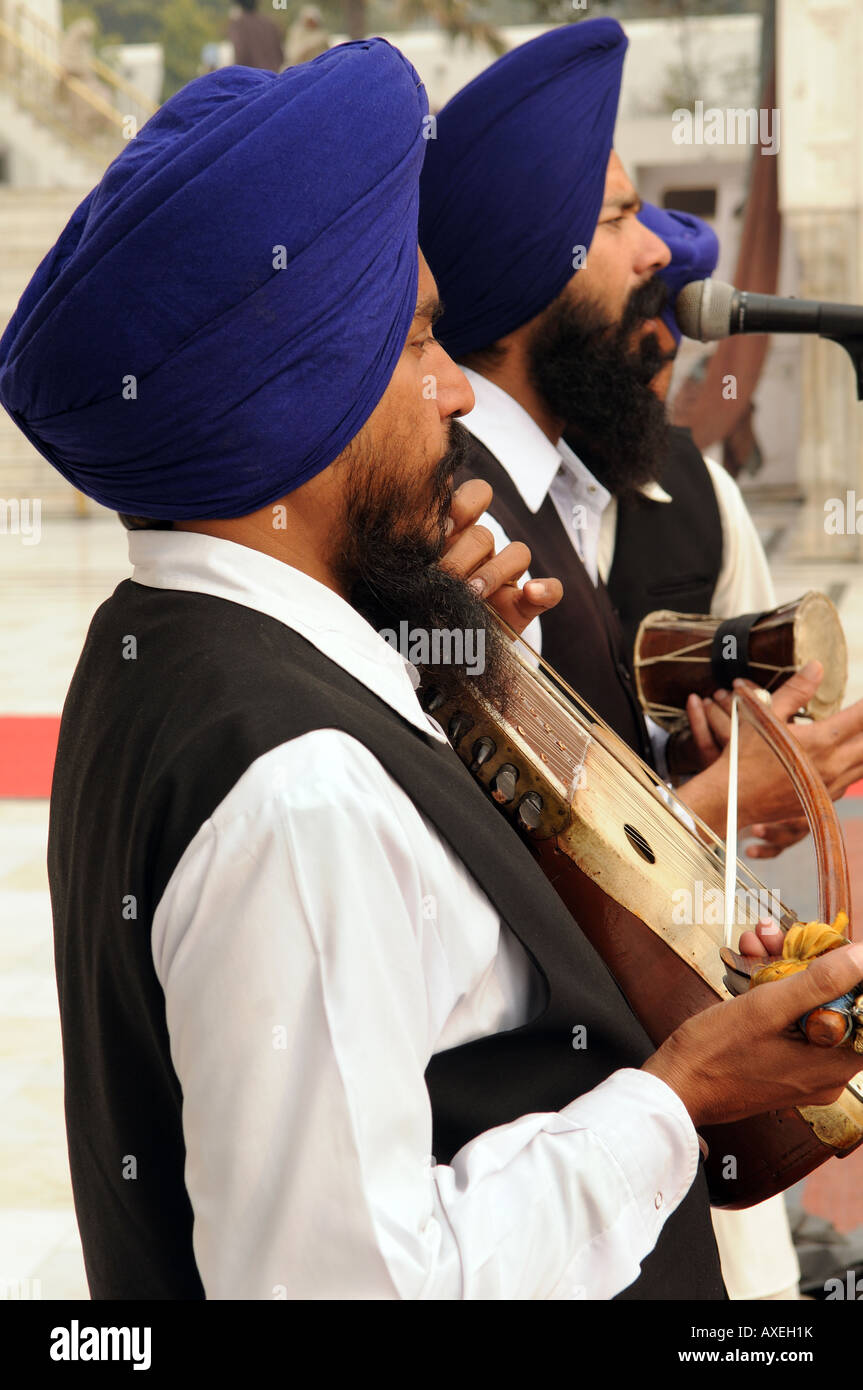 Sikh musicians play traditional musical instruments in the grounds of ...