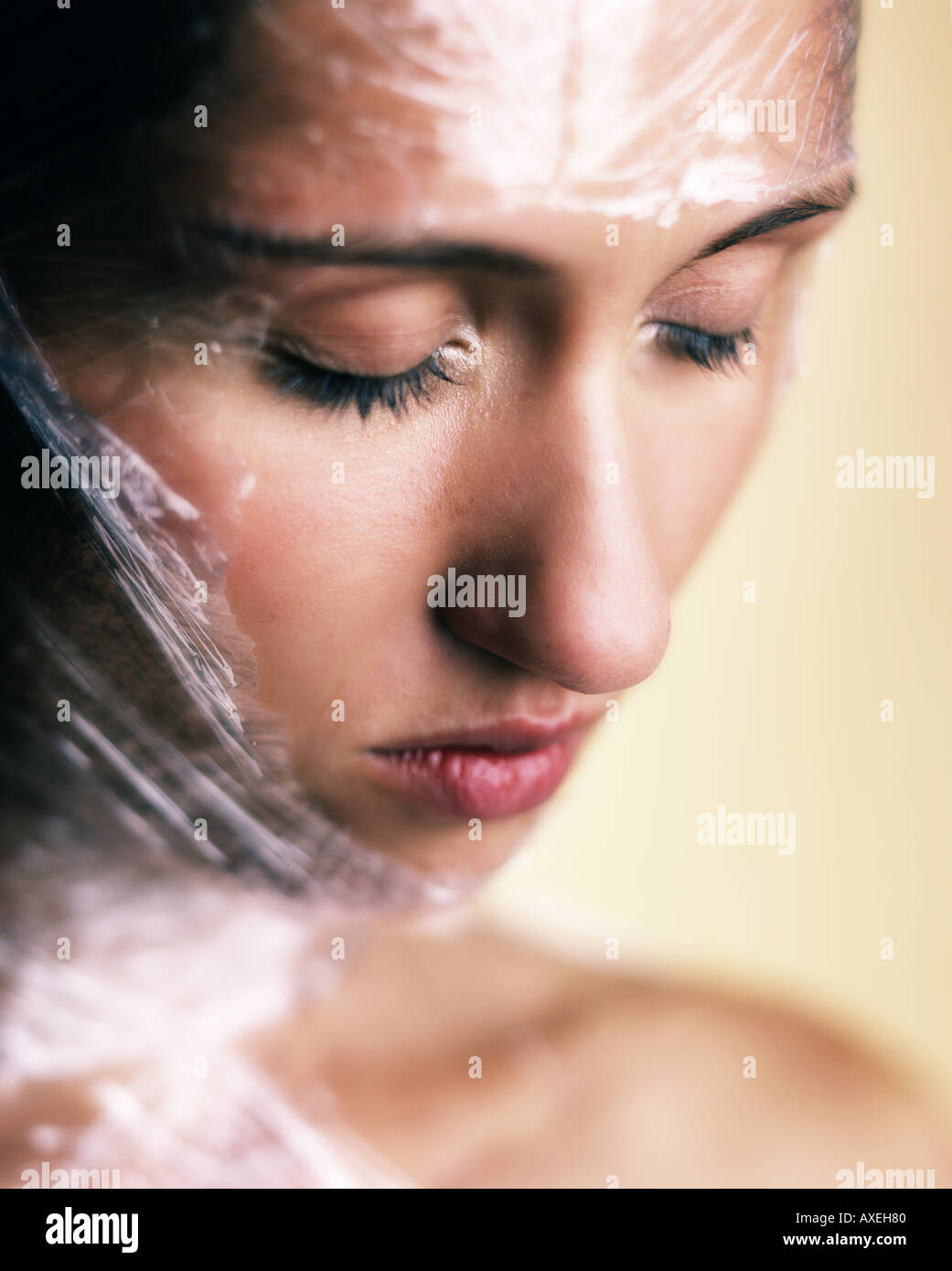 woman young 20 25 girl brunette face close up interior eyes closed make up foil wind wriped ...