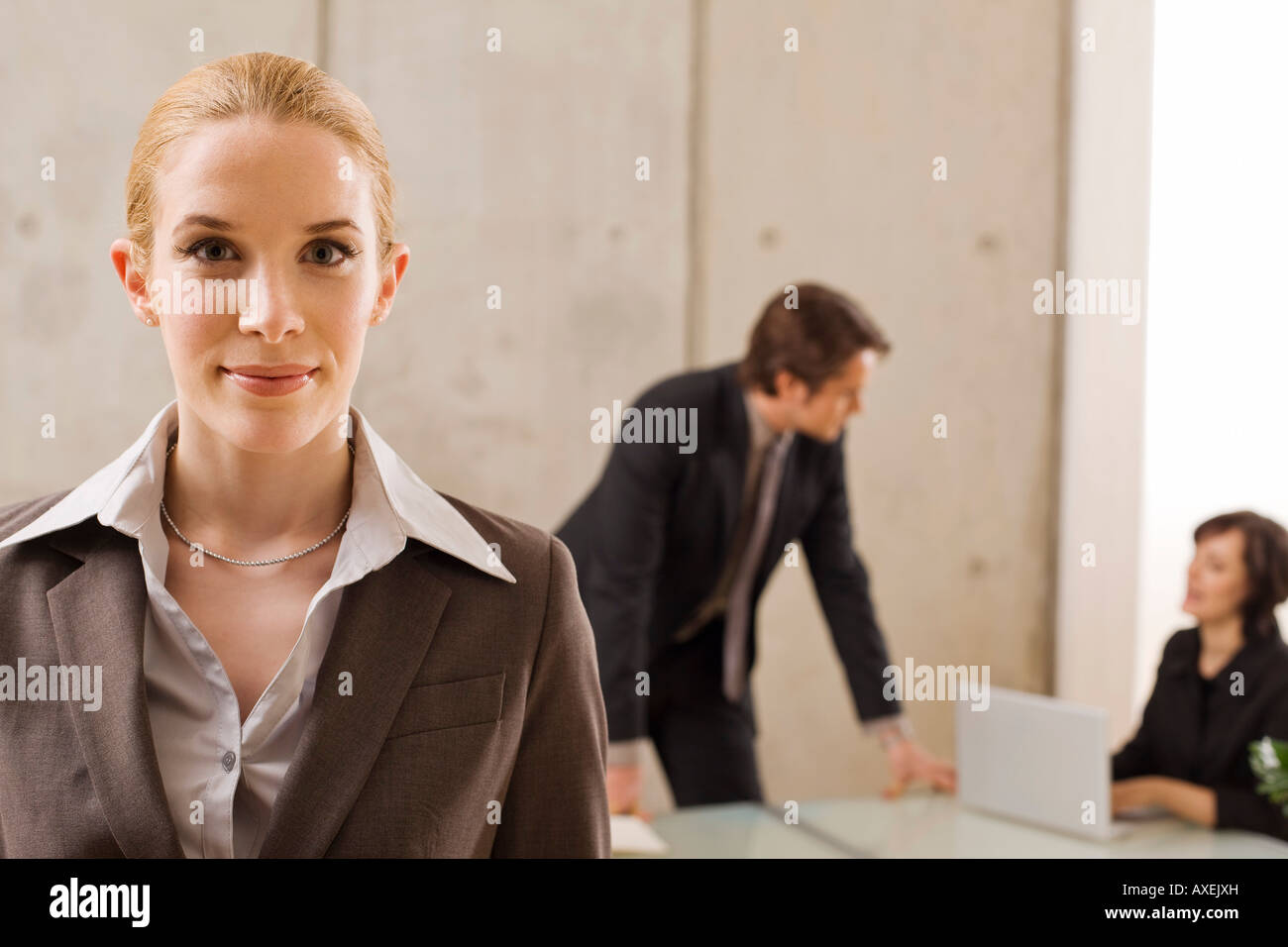 Three business people using a computer Stock Photo - Alamy