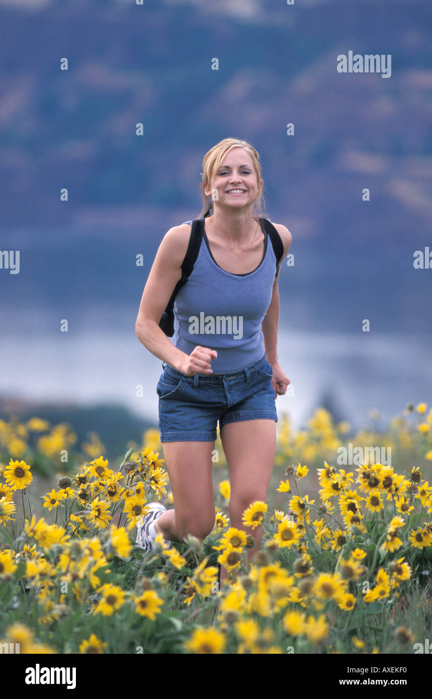Woman running through flowers hi-res stock photography and images - Alamy