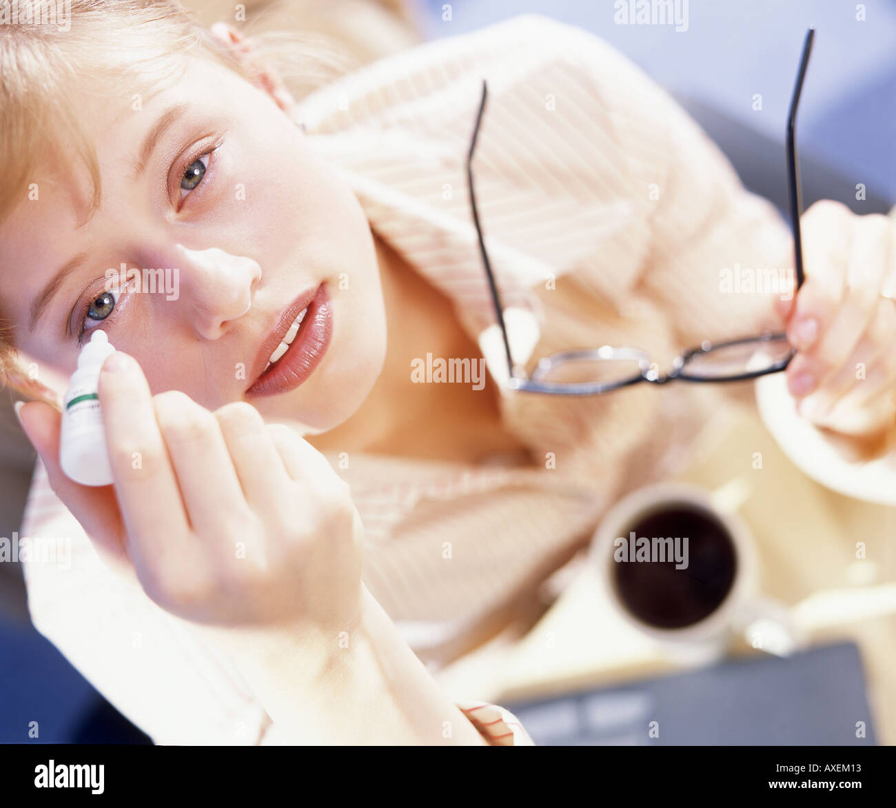 Young woman applying eye drops Stock Photo - Alamy