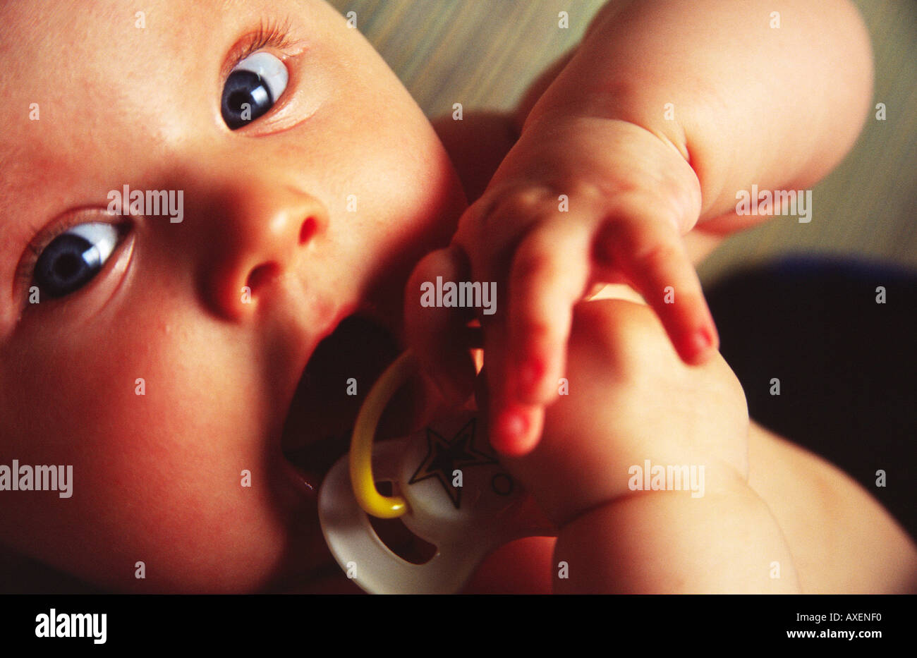 Small baby with pacifier in his mouth Stock Photo - Alamy