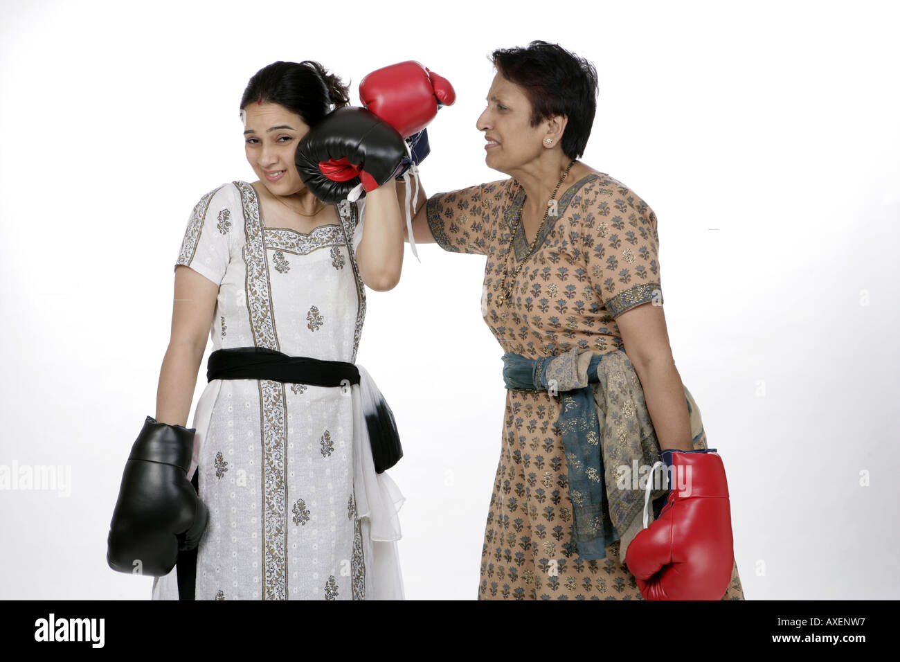 Senior woman fighting with her daughter-in-law with boxing gloves Stock ...