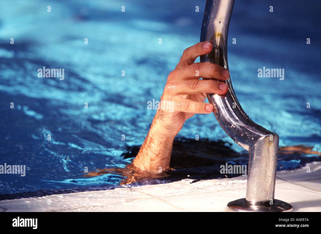 man male adult swim swimmer emerge catch exit to indoor interior pool ...