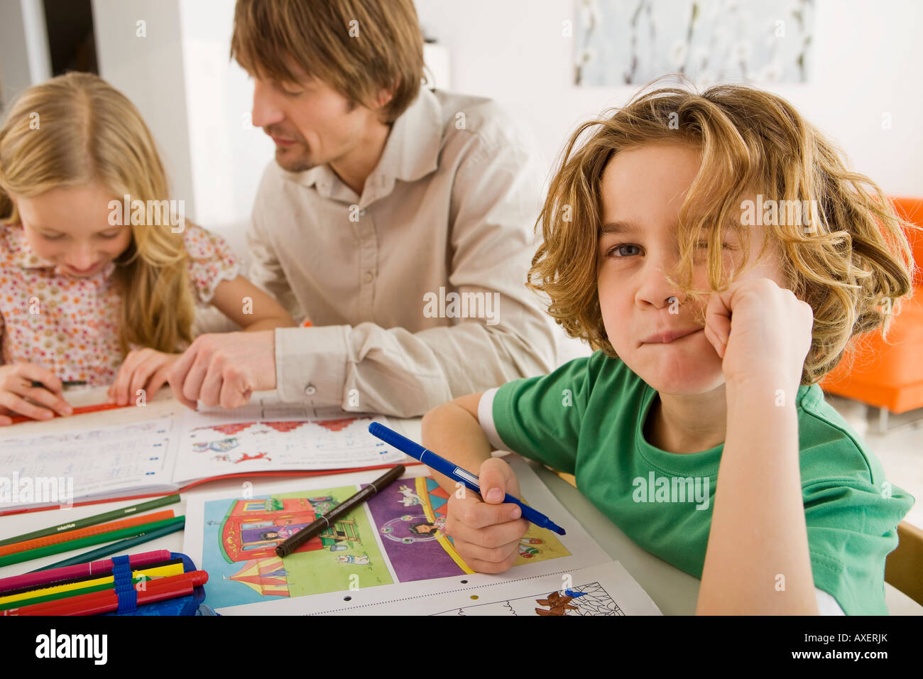 Father and children doing homework Stock Photo - Alamy