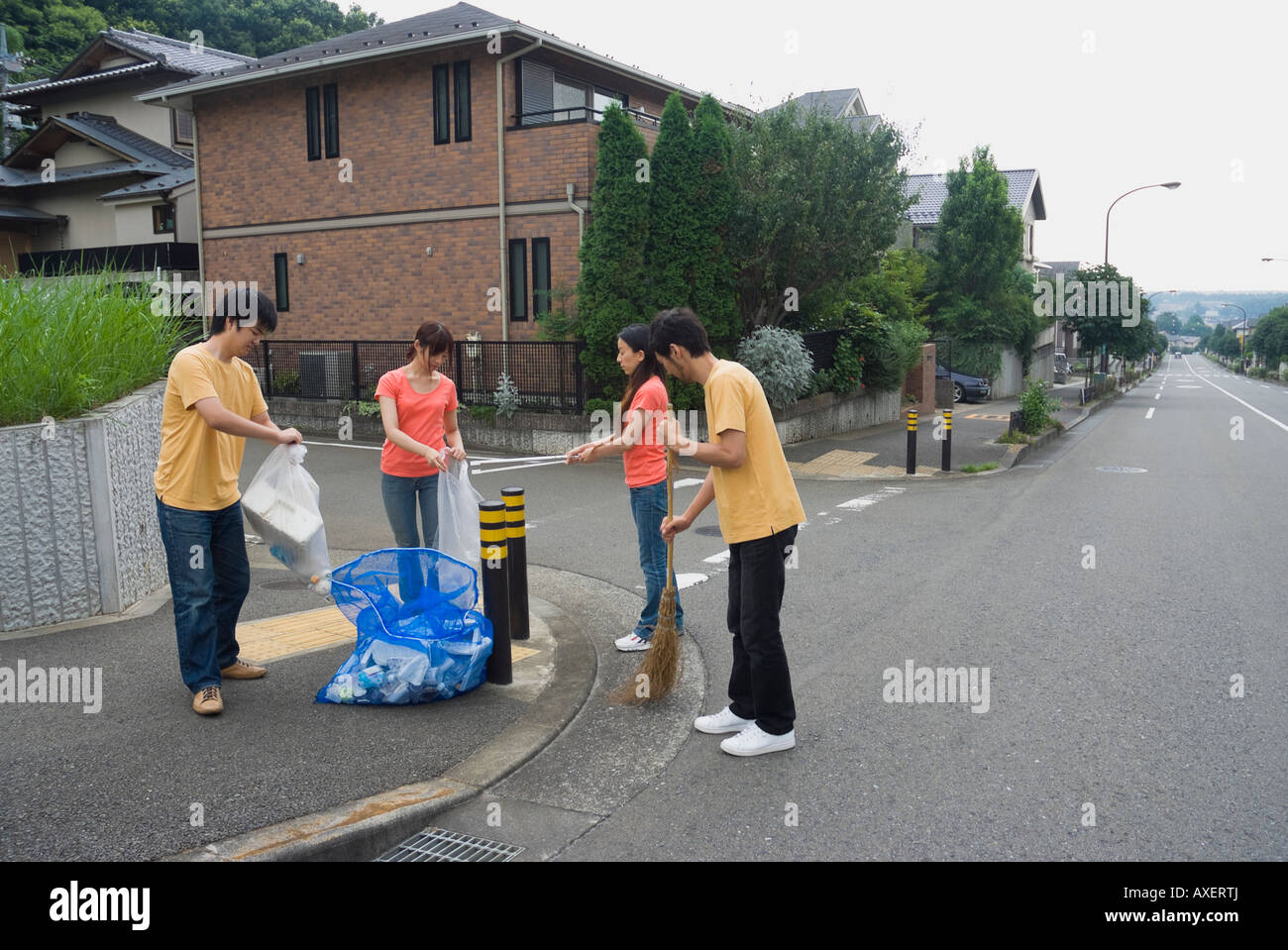Young people cleaning garbage Stock Photo - Alamy