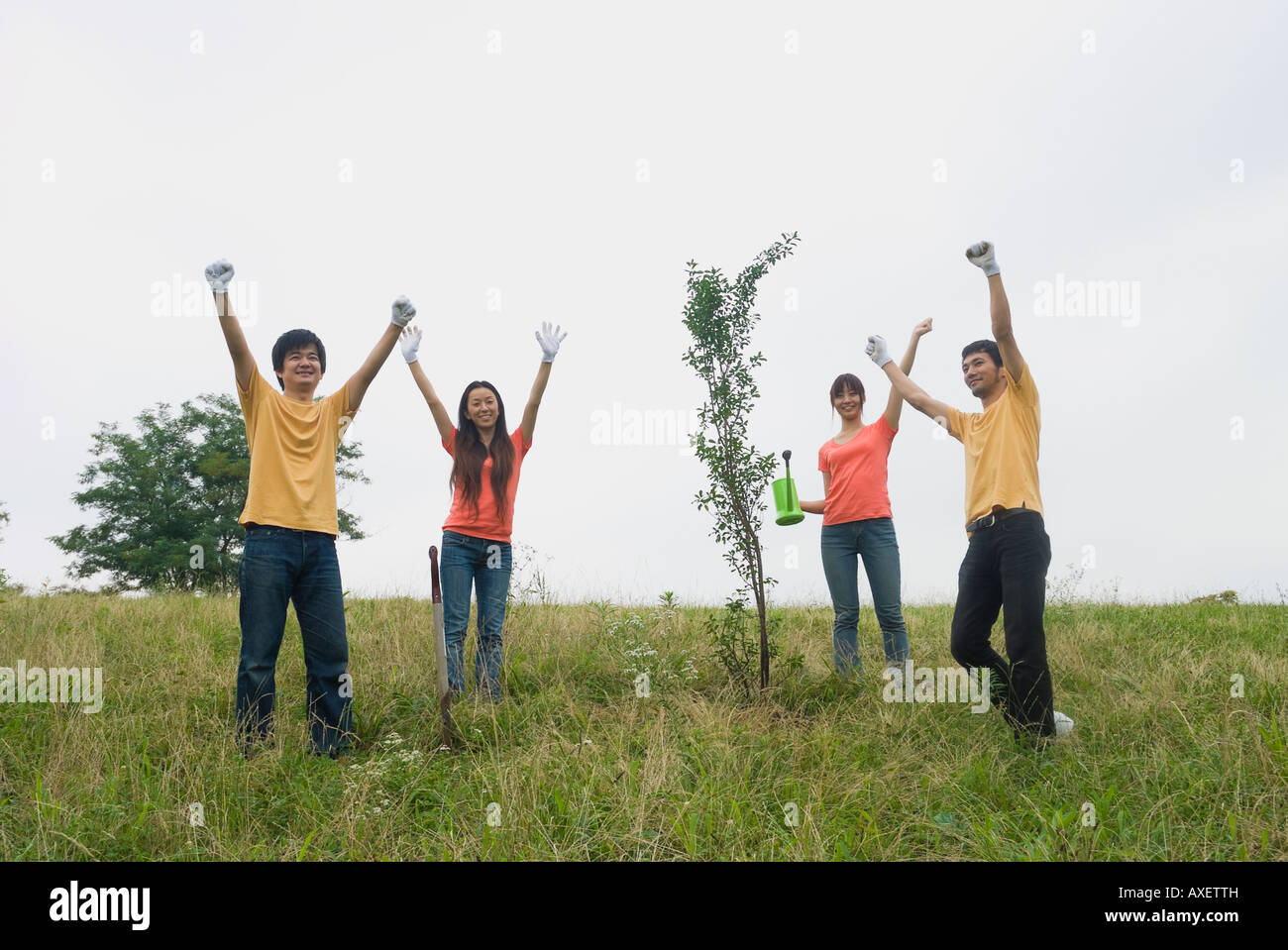 Young people planting tree Stock Photo - Alamy