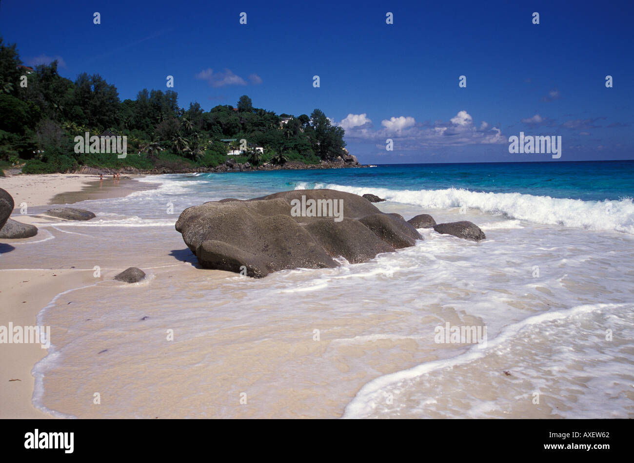 Small breaking waves enclose rock and beach, Seychelles, Indian Ocean ...