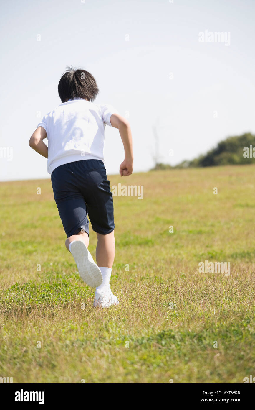 One schoolboy running, rear view Stock Photo - Alamy