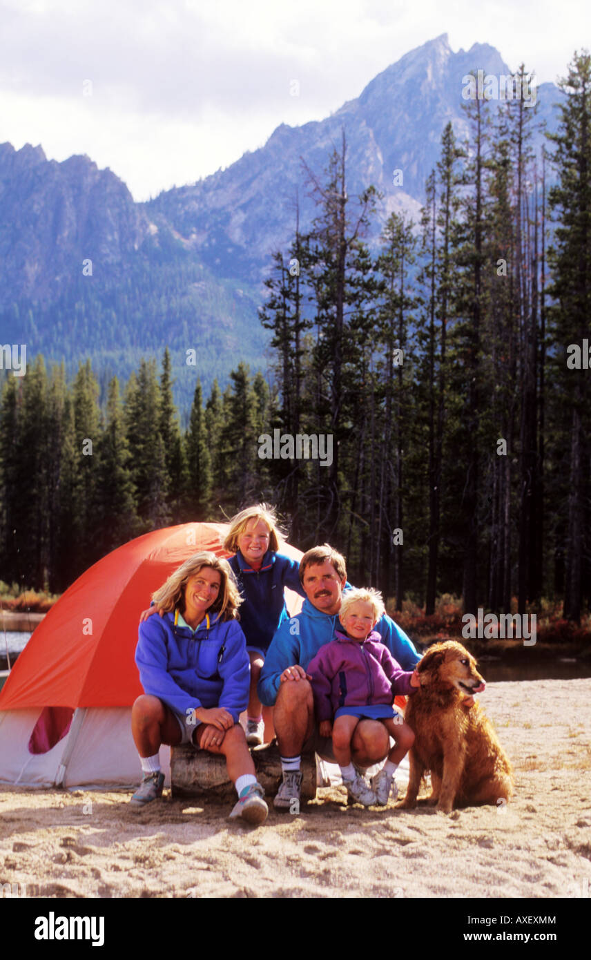 A family poses in front of their tent on camping trip in the Idaho ...