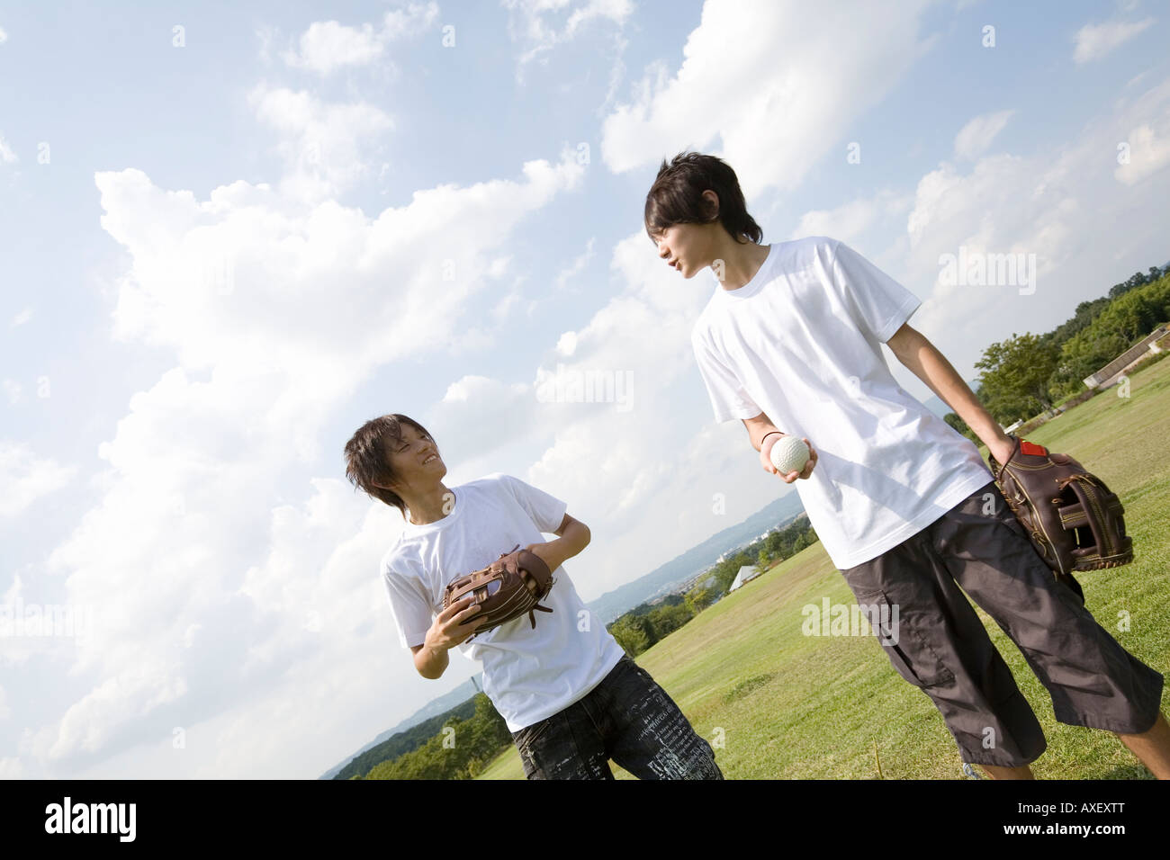 Two teenage boys playing catch Stock Photo - Alamy