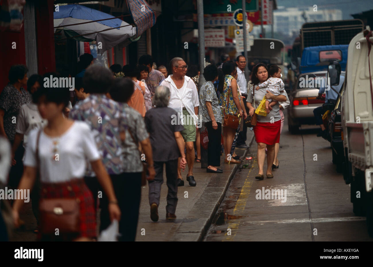 Crowds of Chinese line a street in Macau, China, one of the densely ...