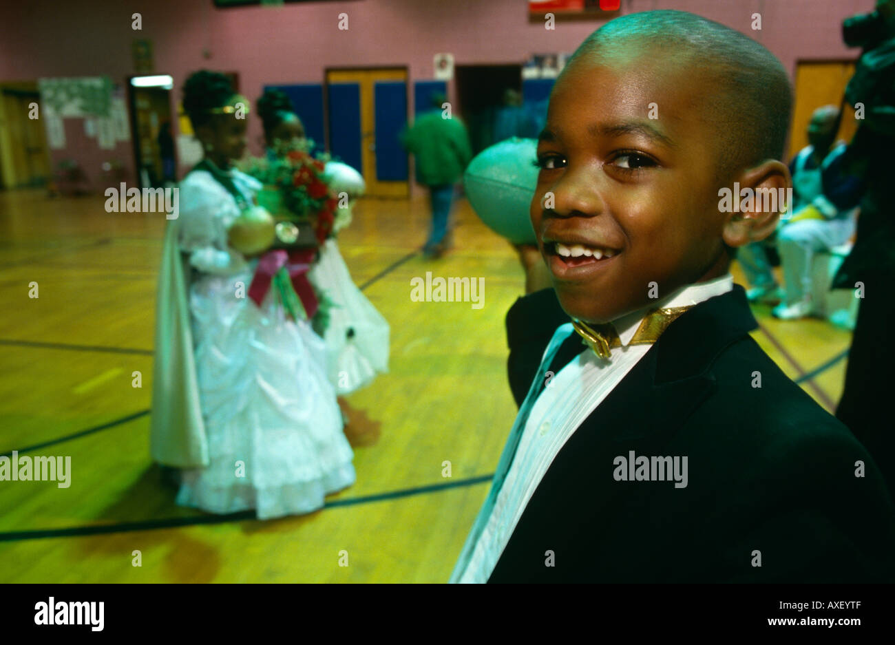 Smartly dressed young black children attend a coronation at the Bedford ...