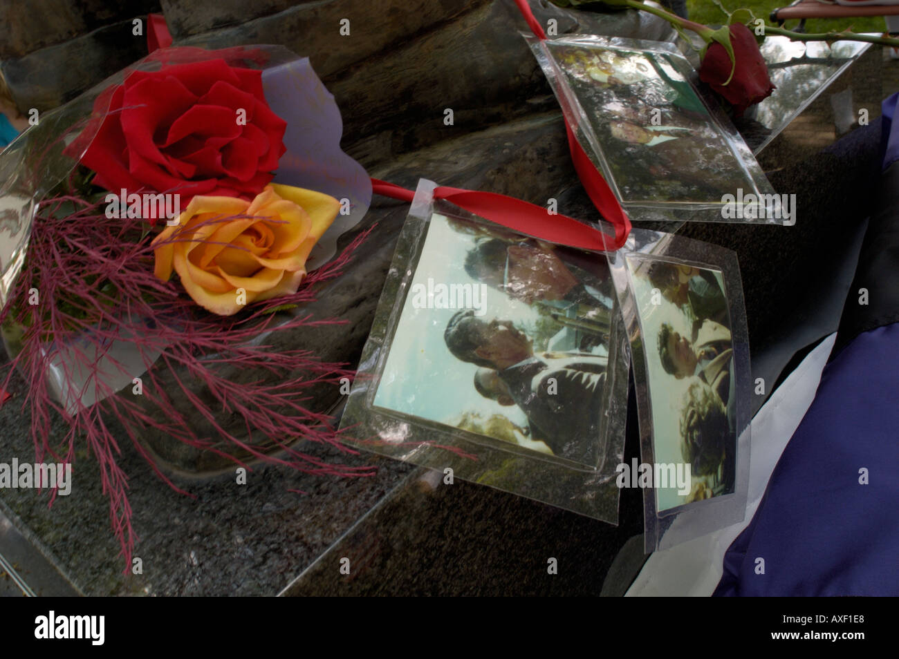 flowers and photographs left at the foot of the statue of Ronald Reagan ...