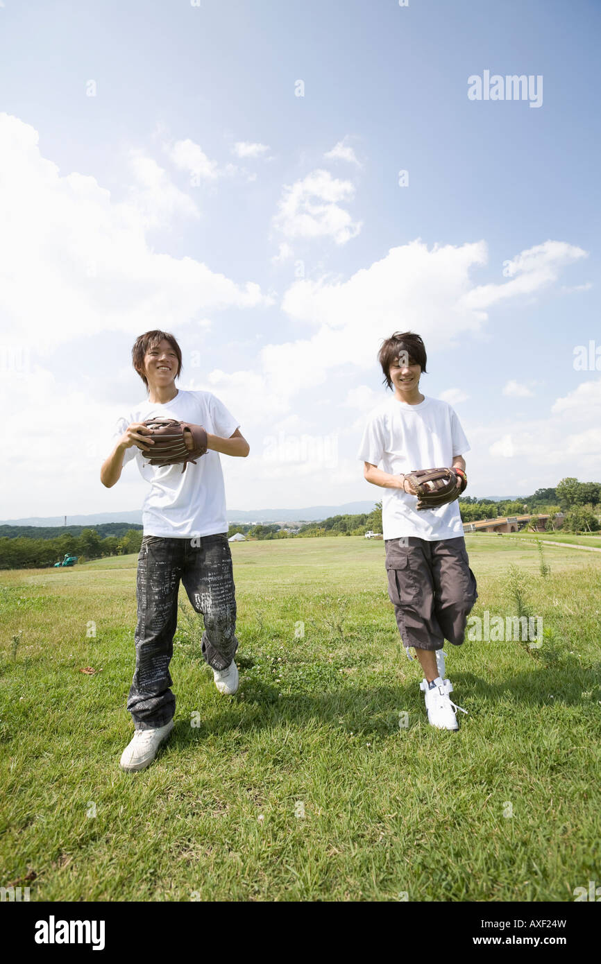 Two teenage boys playing catch Stock Photo - Alamy