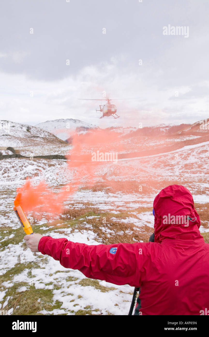 A smoke flare attracts an Air ambulance to a mountain rescue casualty ...