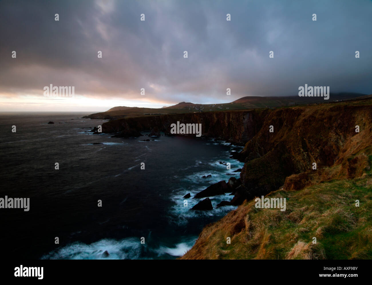 Dark clouds and mute colours colors in a dramatic sky over the Dingle ...