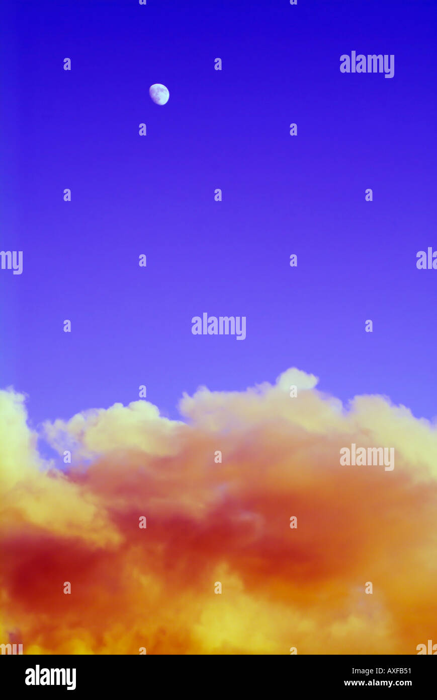 Moon rising over clouds lit by the setting sun Stock Photo - Alamy