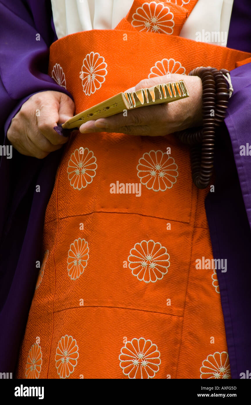 A man dressed in Heian period costume holds a fan at the Gokusui no en ...