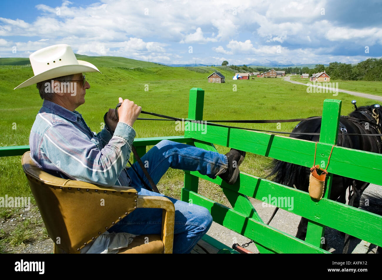 A rancher guides his horses at the Bar U Ranch National Historic Site ...