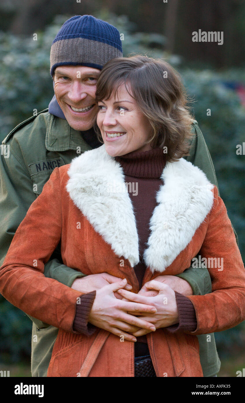 couple in their thirties hug in the forest Stock Photo - Alamy