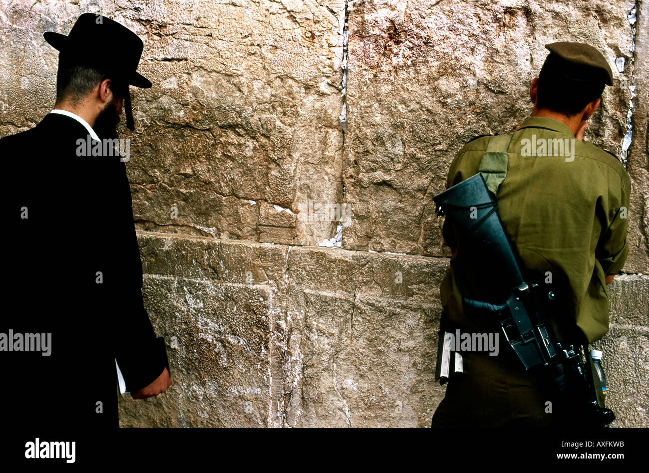 A Orthodox Jew and soldier praying at the western wall together Stock ...