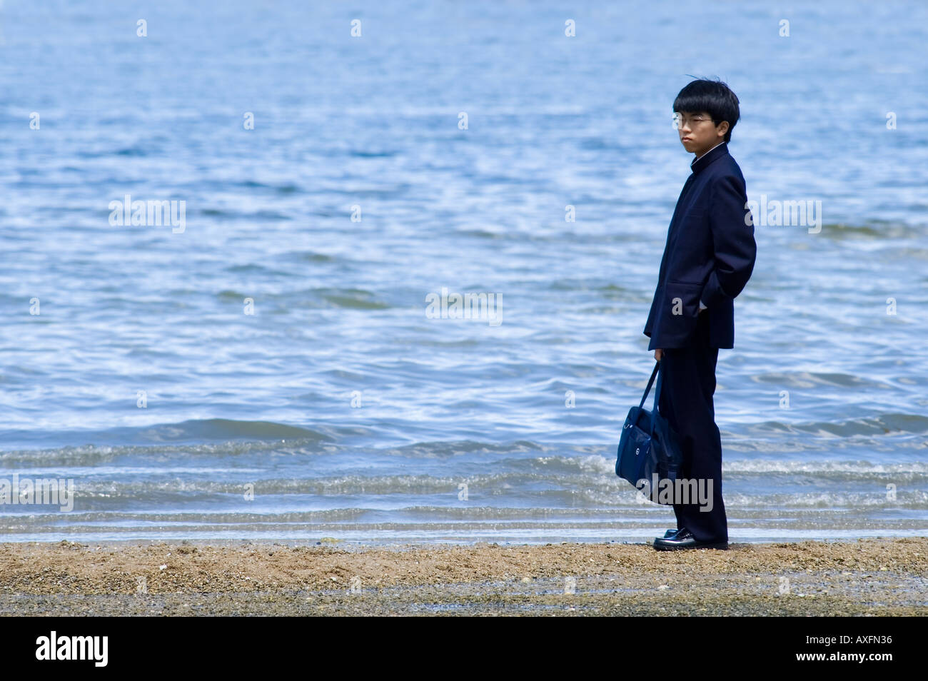 Boy stands alone outside hi-res stock photography and images - Alamy