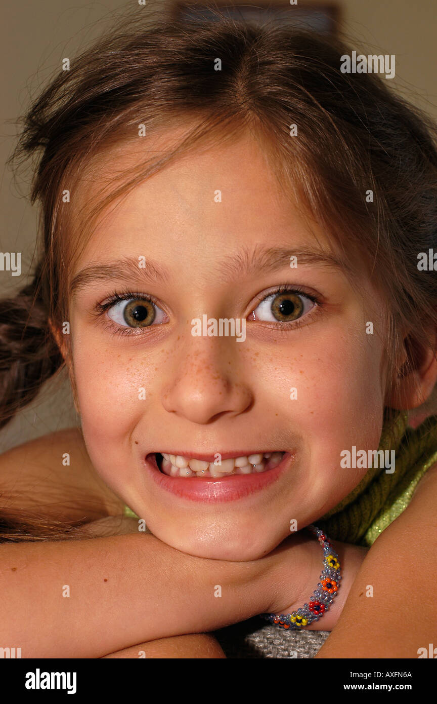 Girl with big eyes smiling (age of 8 Stock Photo - Alamy