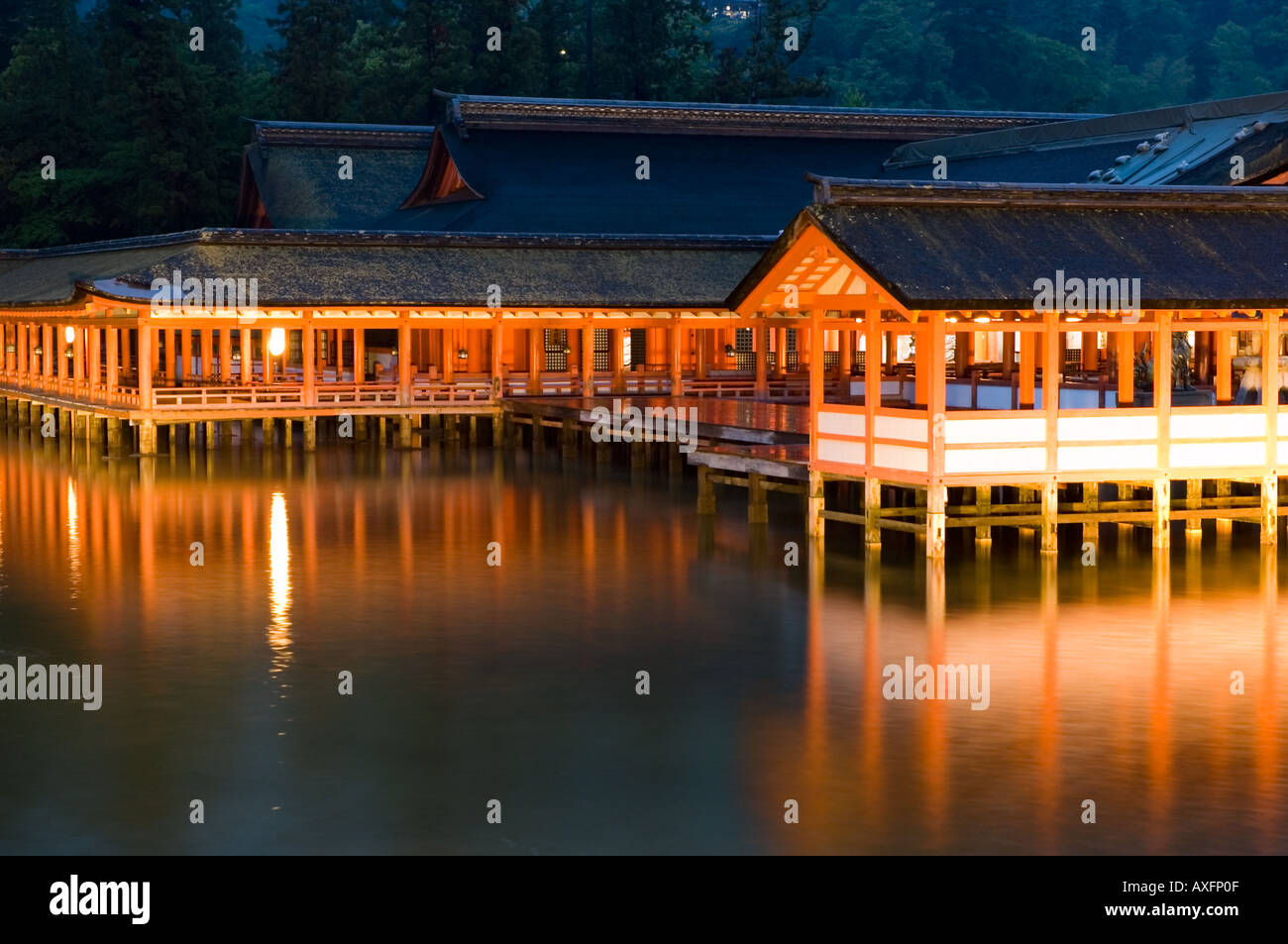 Itsukushima Shrine is illuminated at night on MiyaJima and reflected in ...