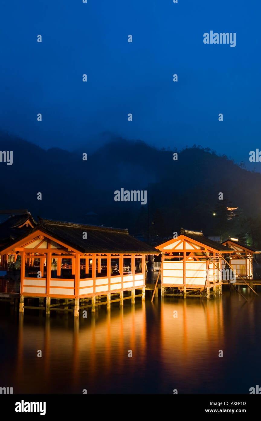 Itsukushima Shrine is illuminated at night on MiyaJima and reflected in ...