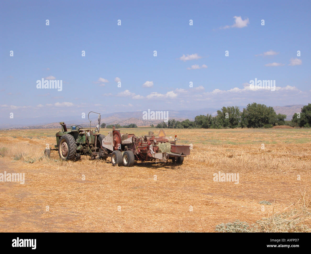 hay baler and tractor, on a farm in central California Stock Photo - Alamy