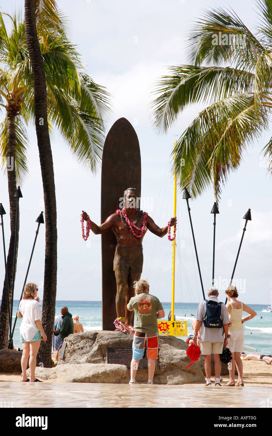 TOURISTS AND LOCALS LEAVE LEIS IN TRIBUTE AT THE STATUE OF DUKE PAOA ...