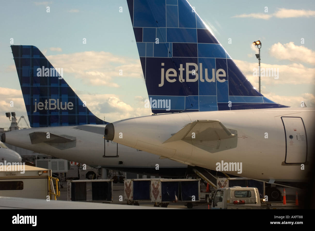 Jet Blue airliner tails sit parked on the runway at JFK airport Stock ...