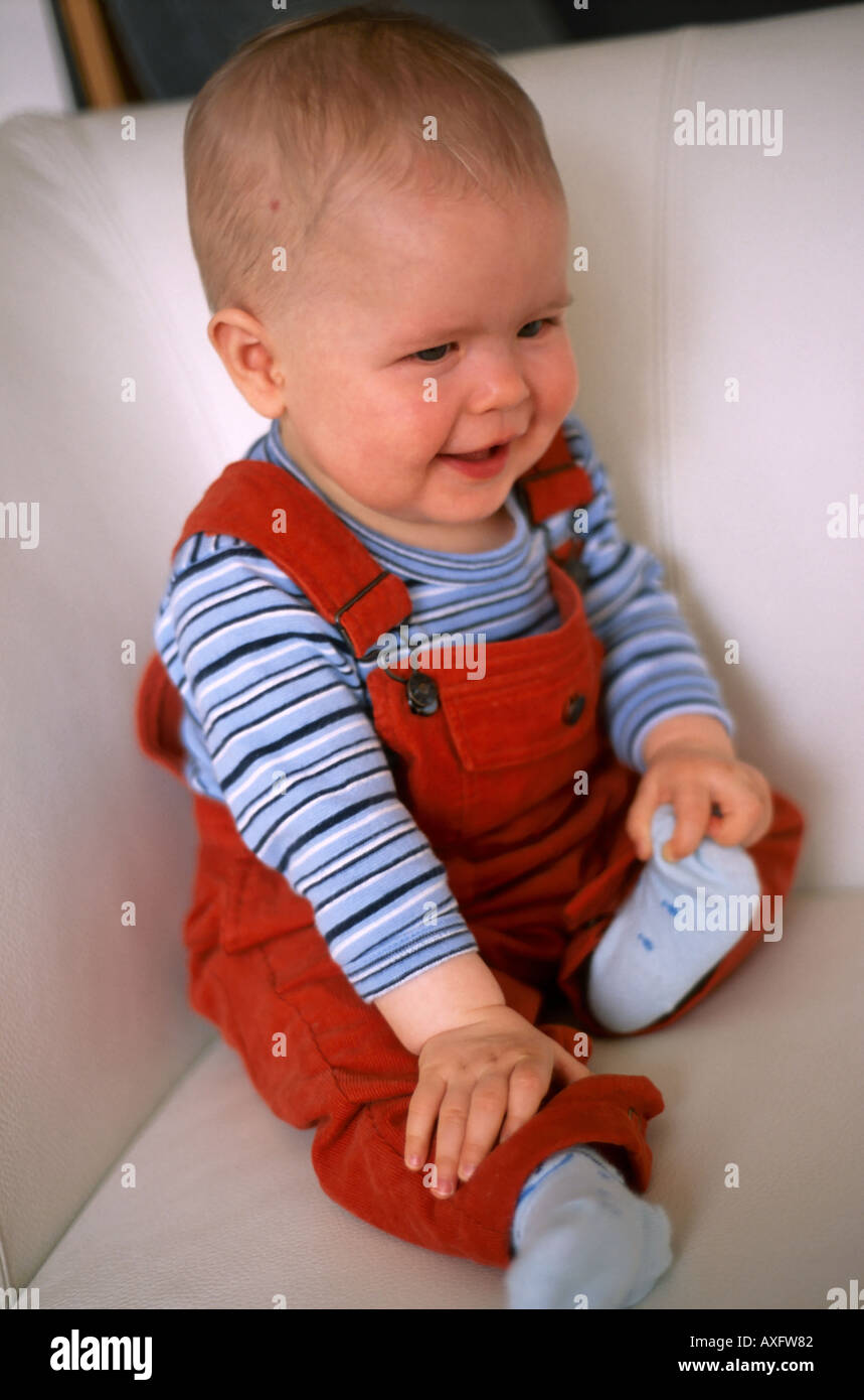 indoor flat room child baby 0 5 sit armchair smile smiling portrait ...