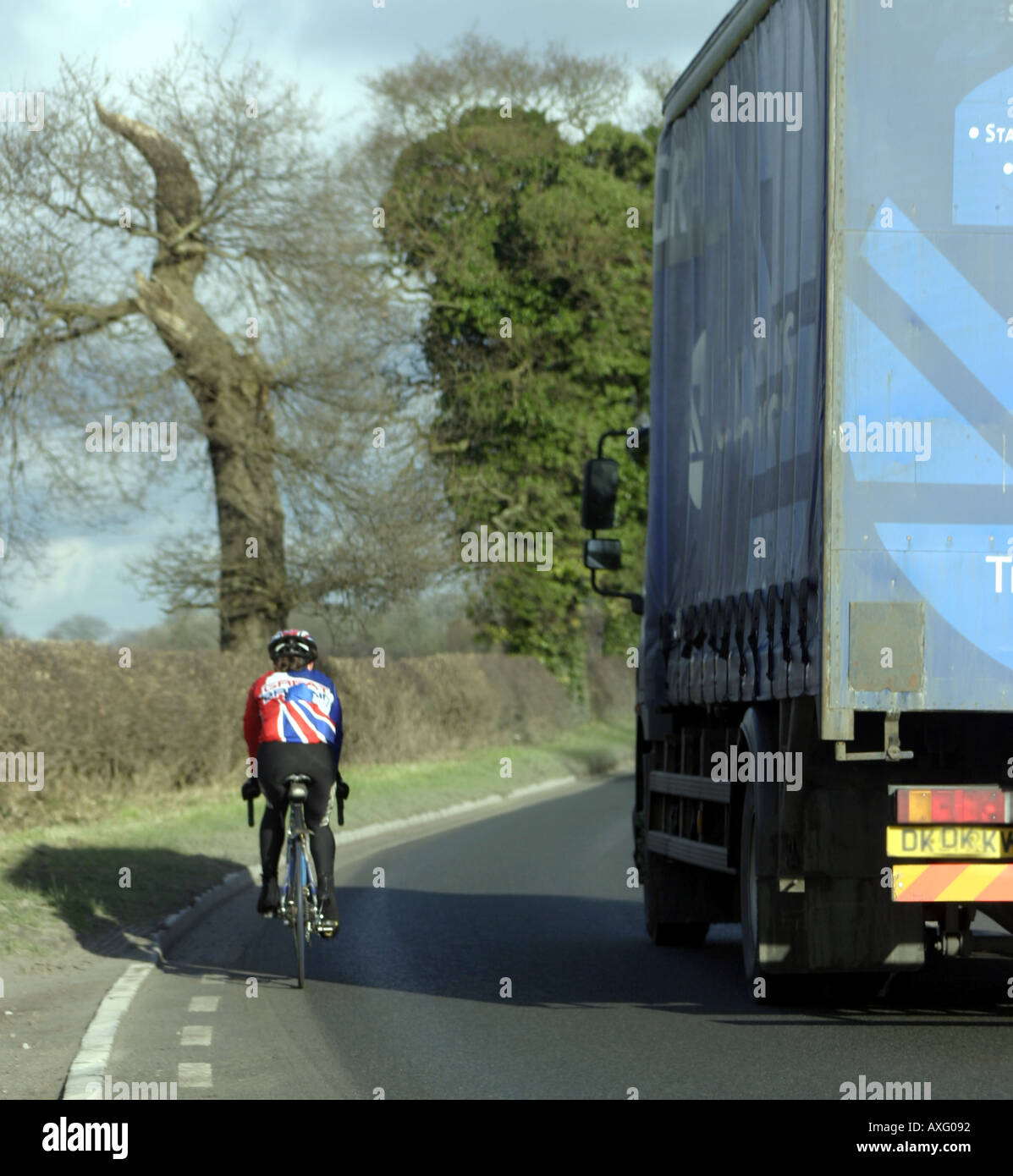 Cyclist on a busy main road Stock Photo - Alamy