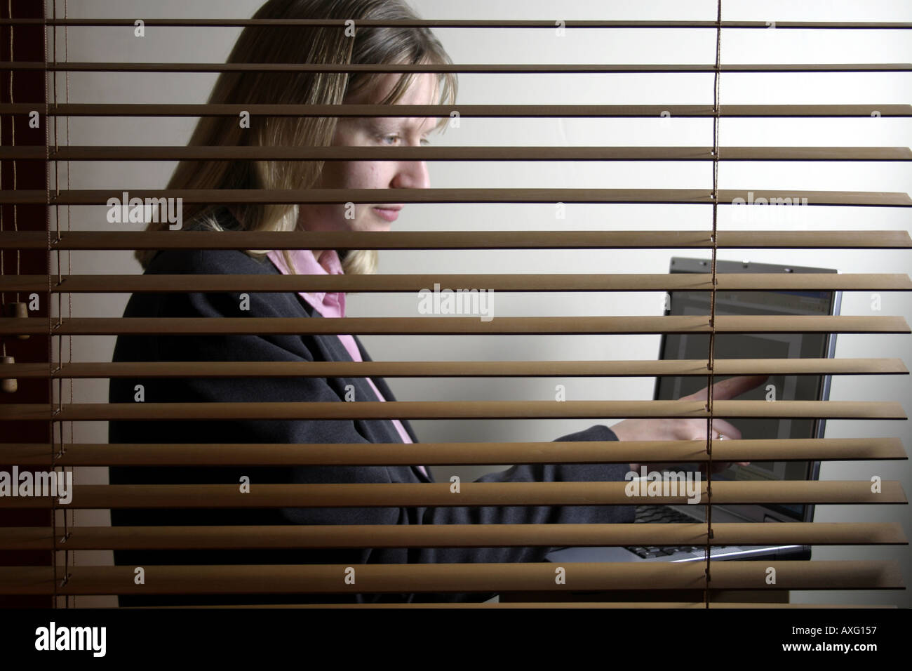 Business woman or secretary pointing out something on her computer in ...