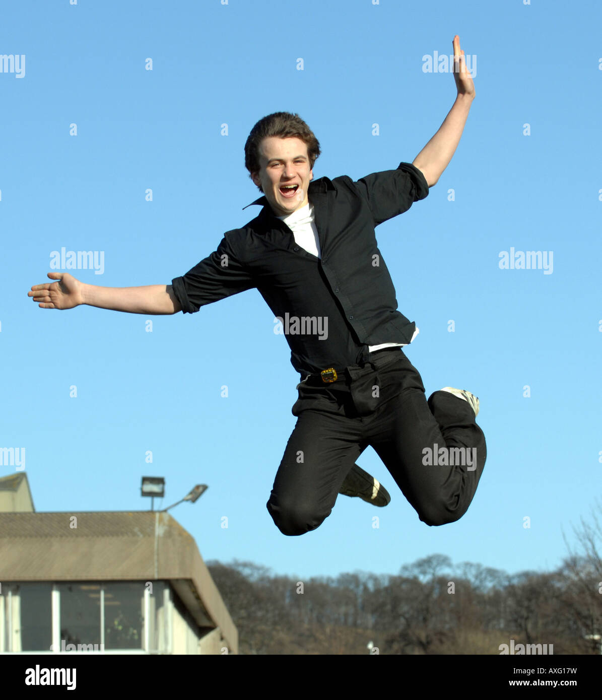 Happy Teenage boy jumping for Joy Stock Photo - Alamy