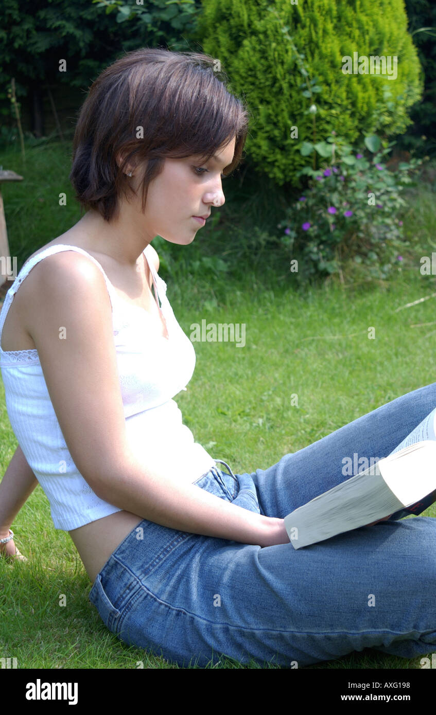 teenage girl reading a book outside Stock Photo - Alamy