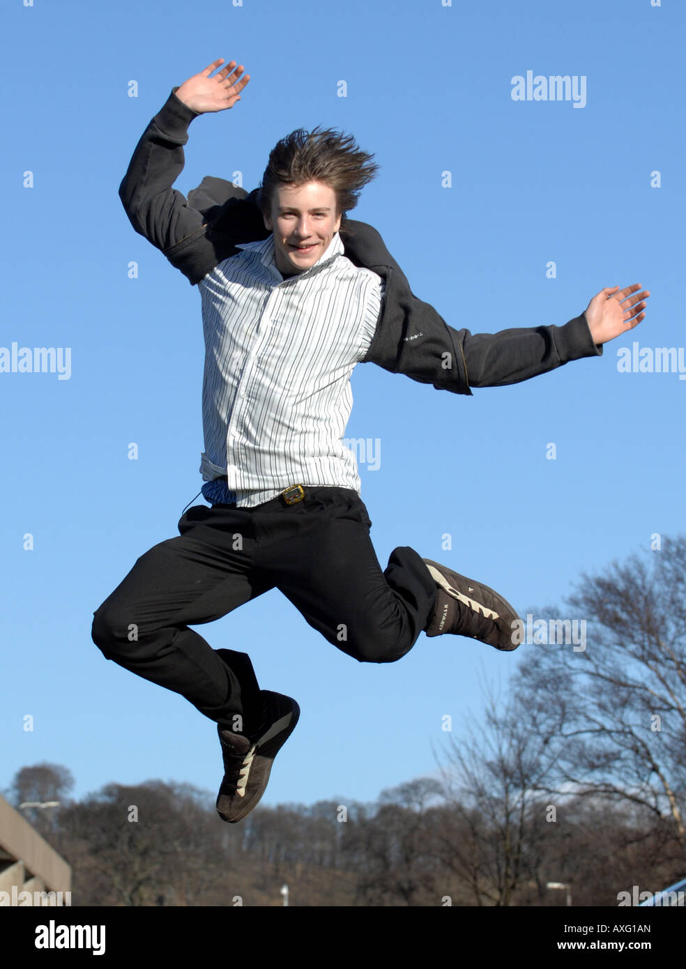 Happy Teenage boy jumping for Joy Stock Photo - Alamy
