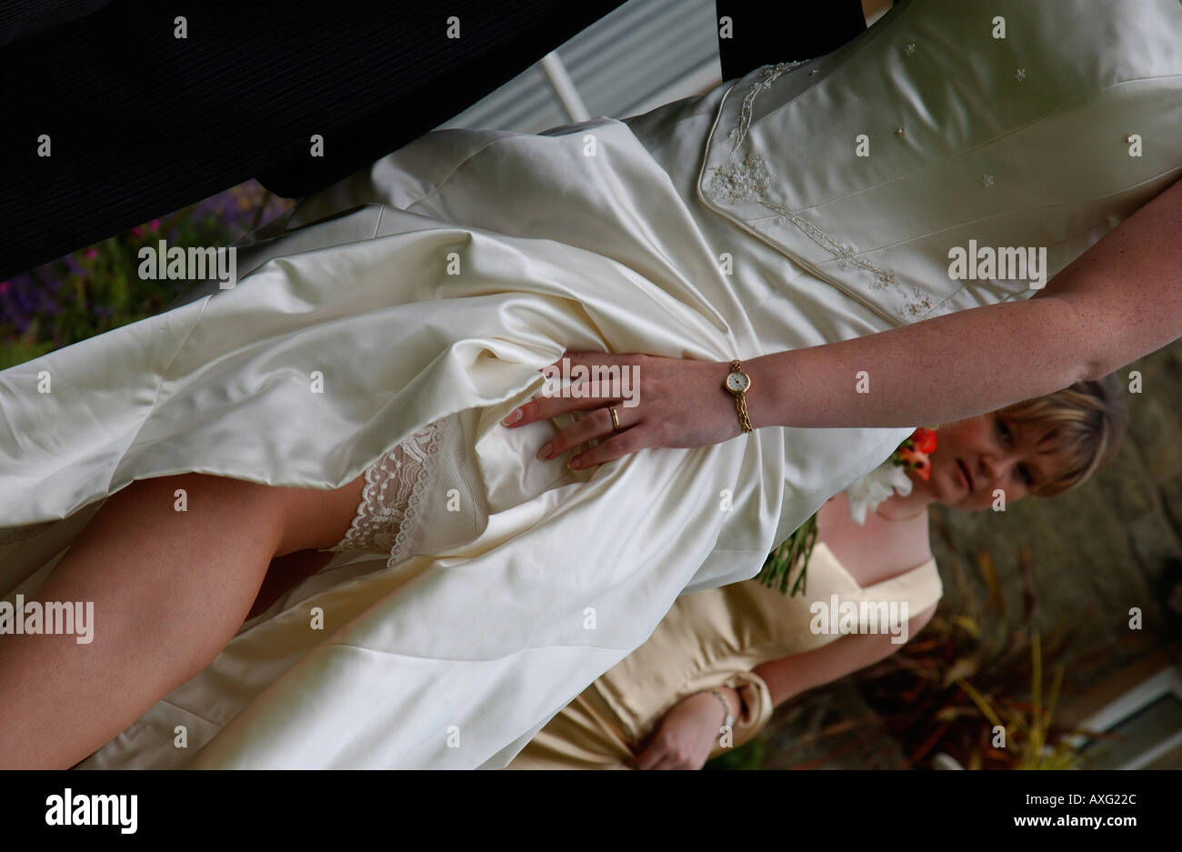 bride showing garter at wedding Stock Photo - Alamy