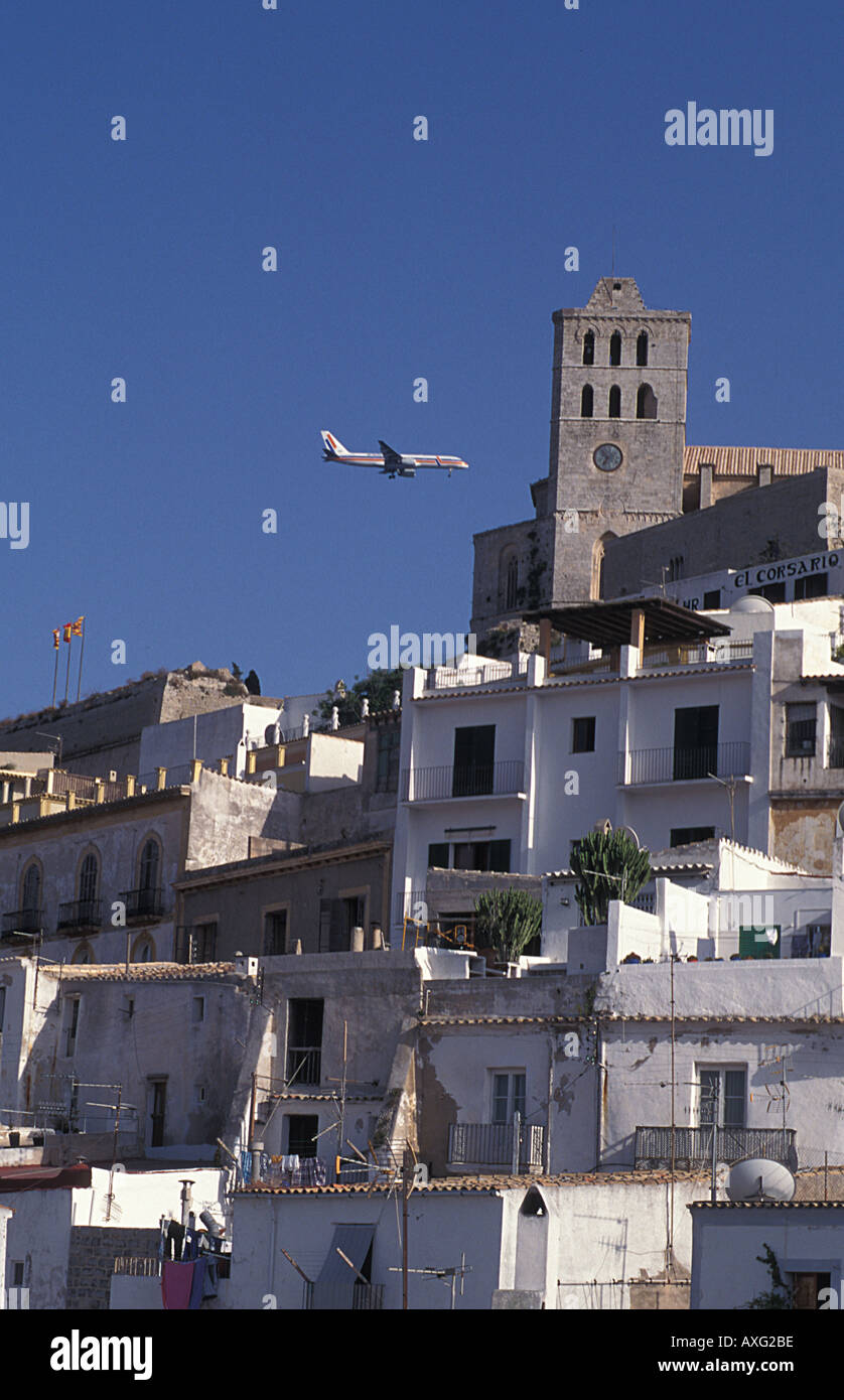 Plane flying of Ibiza old town Spain Stock Photo - Alamy
