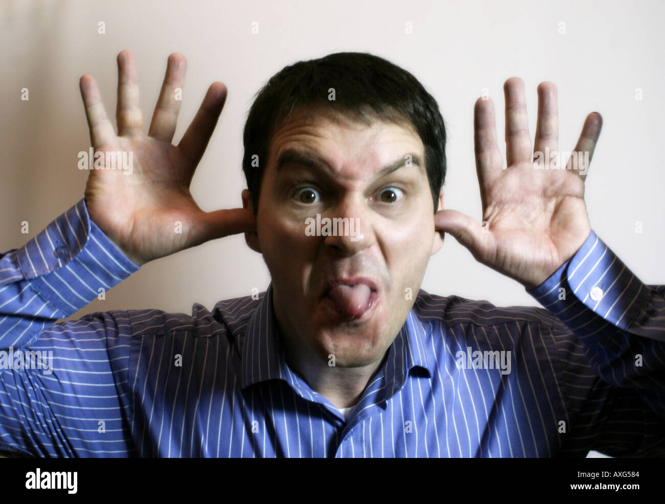 man arrogantly pulling a rude face Stock Photo - Alamy