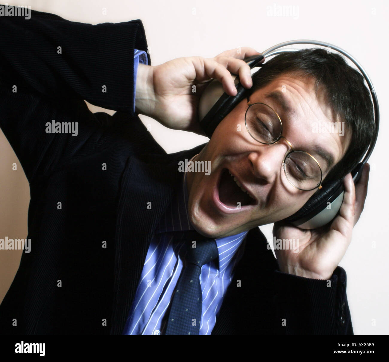 Singing businessman listening music headphones hi-res stock photography ...