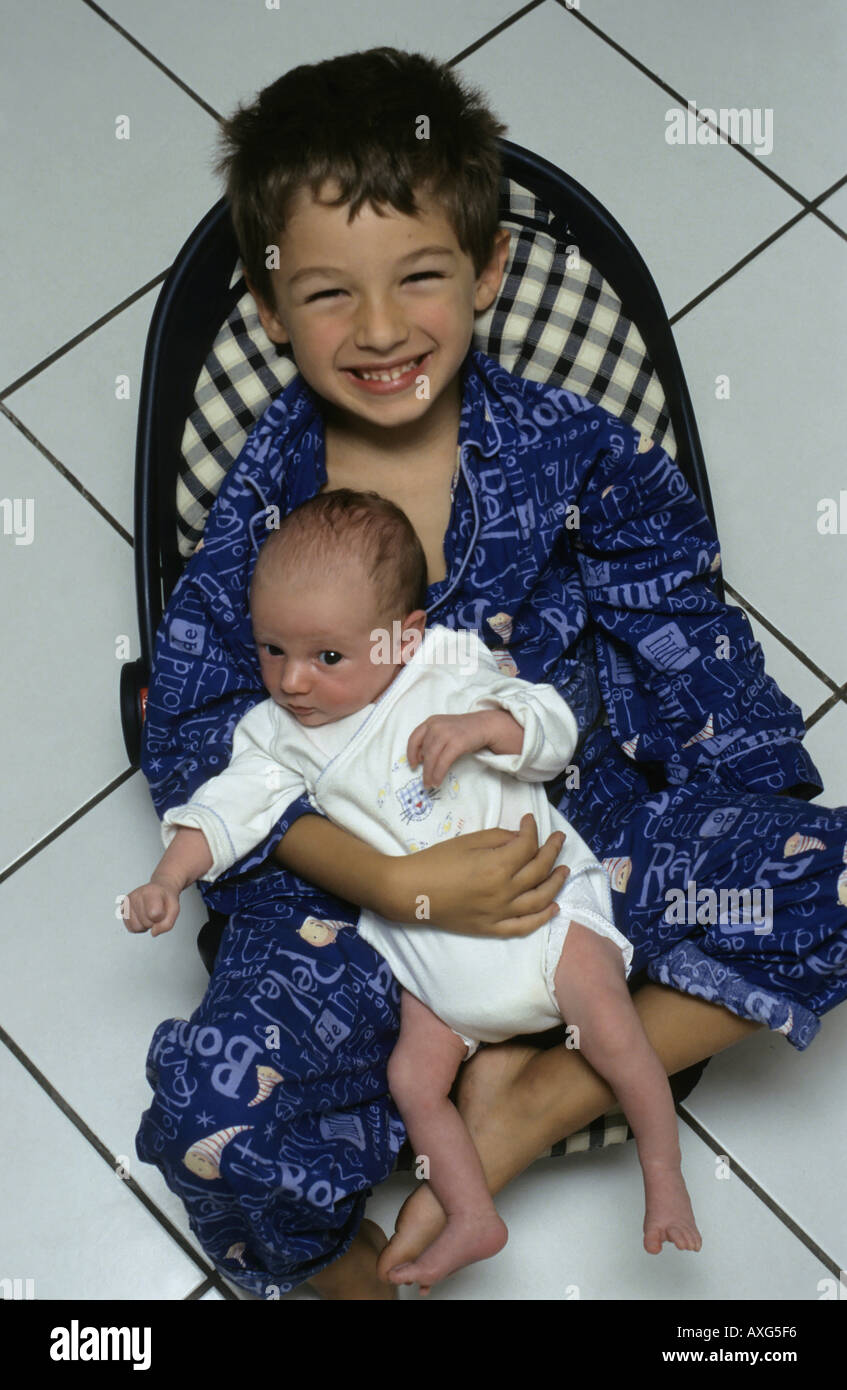 Brother hugging newborn sister hi-res stock photography and images - Alamy