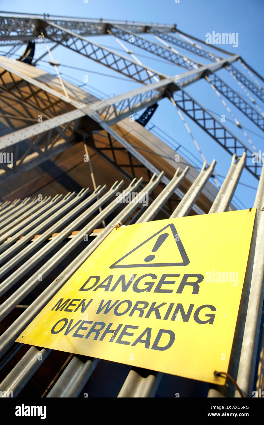 Danger men working overhead sign Stock Photo - Alamy